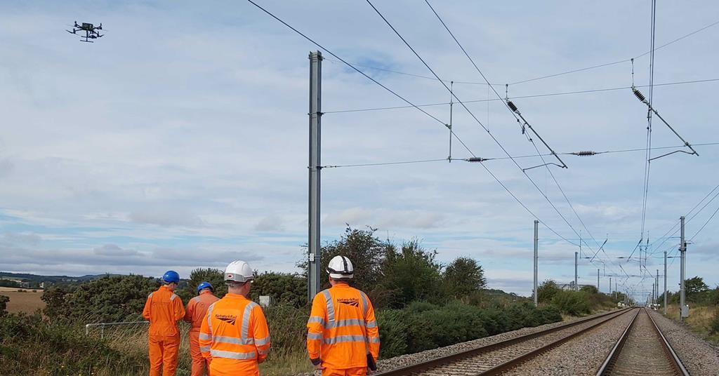 Infrastructure: Connected workers inspect catenary | In depth | Railway ...